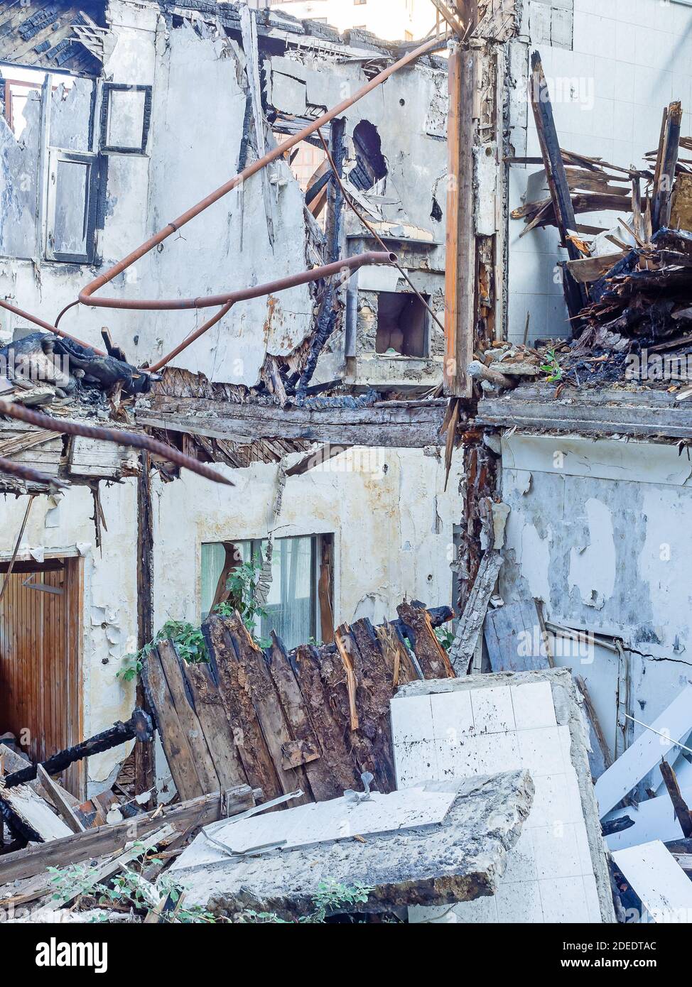 The walls of a ruined residential building with scattered wall debris ...