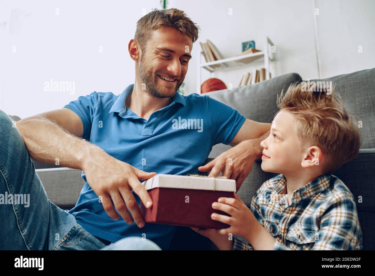 Little son gives his father a gift box for father's day Stock Photo - Alamy