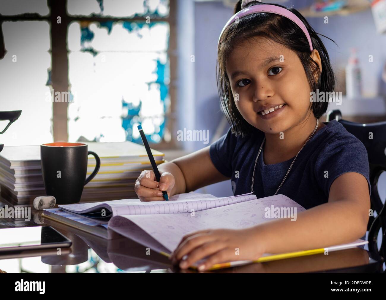Indian girl writing hi-res stock photography and images - Alamy
