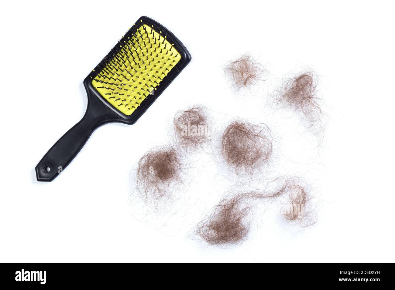 Loose hair clumps and hair brush on white background Stock Photo - Alamy