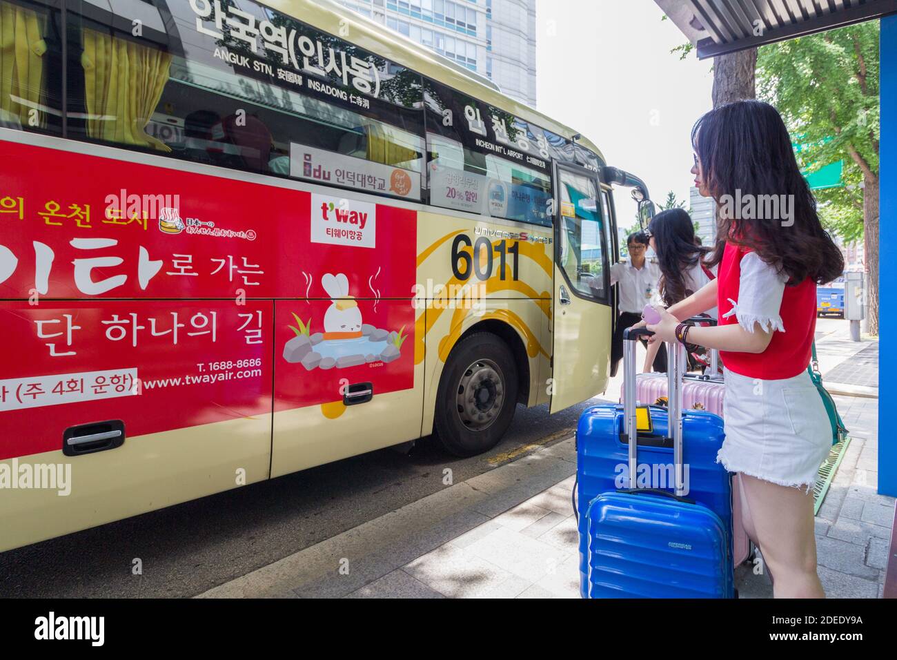 Woman luggage board bus hi-res stock photography and images - Alamy