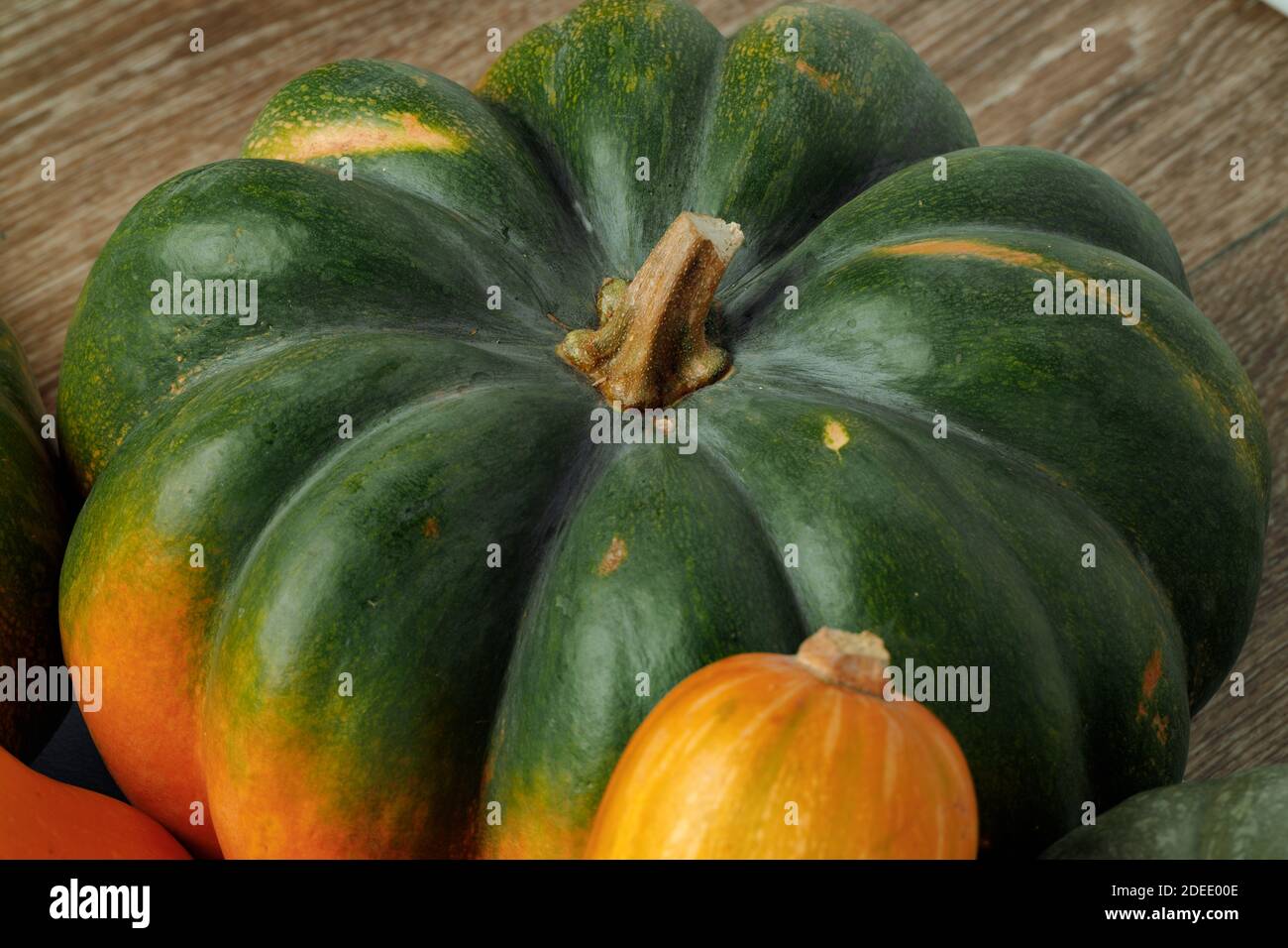 One green pumpkin on brown wooden background Stock Photo - Alamy