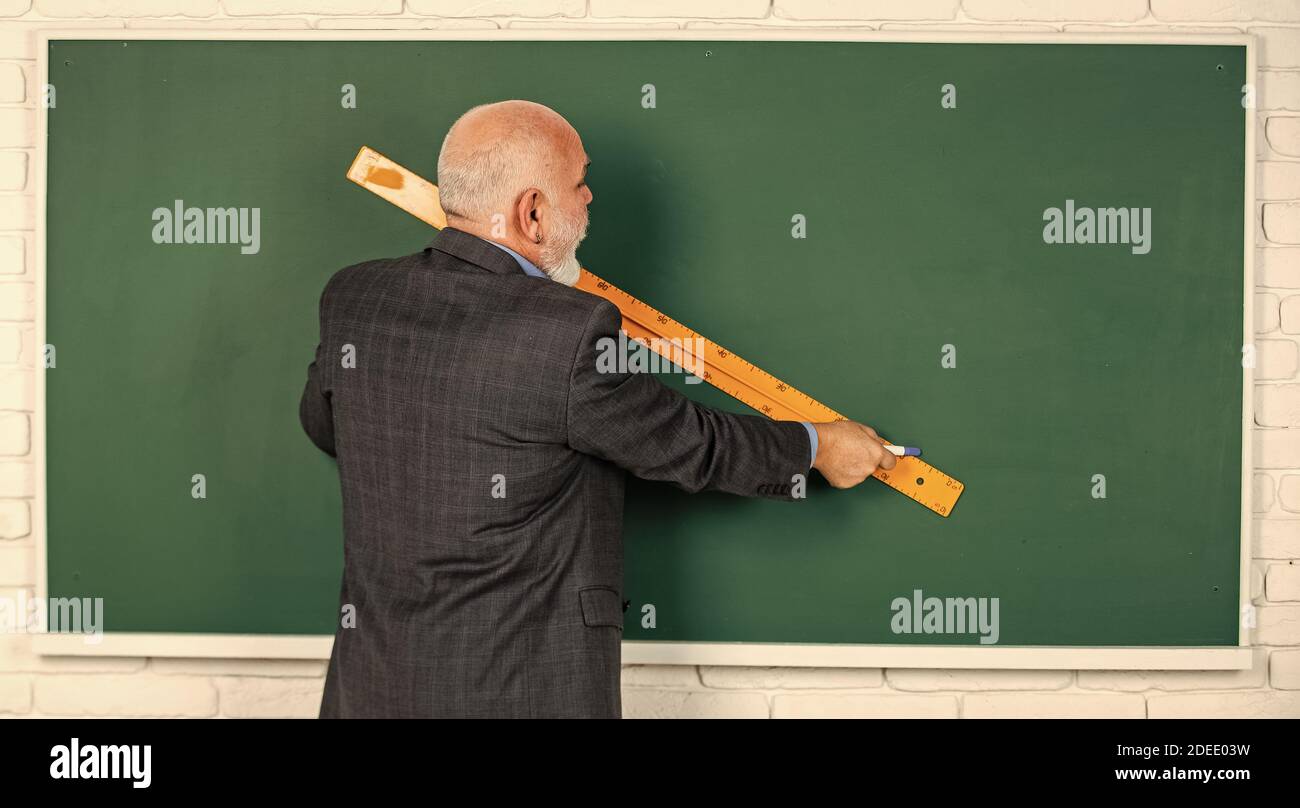 senior man teacher use ruler while drawing. bearded tutor man draw with ...