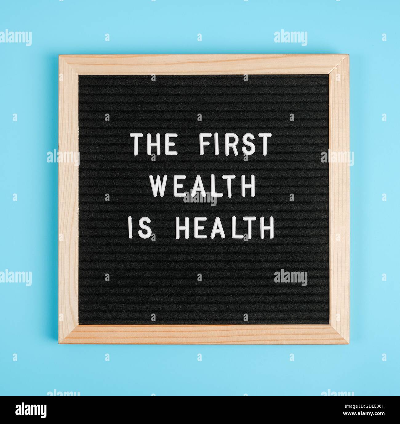 The first wealth is health. Motivational quote on black letter board on ...