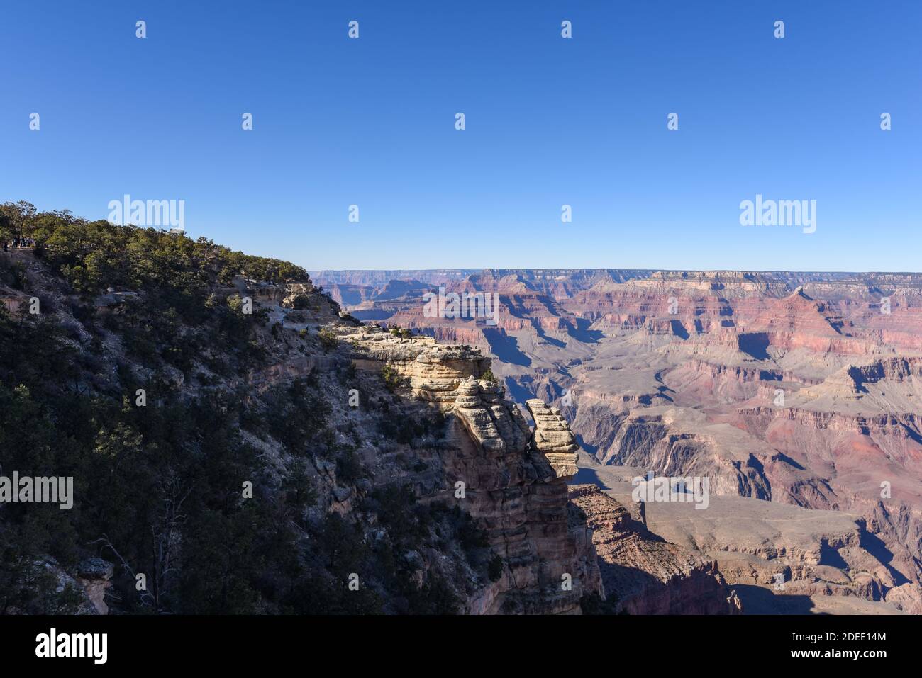 People looking over a ledge at the grand canyon with no safety rails ...