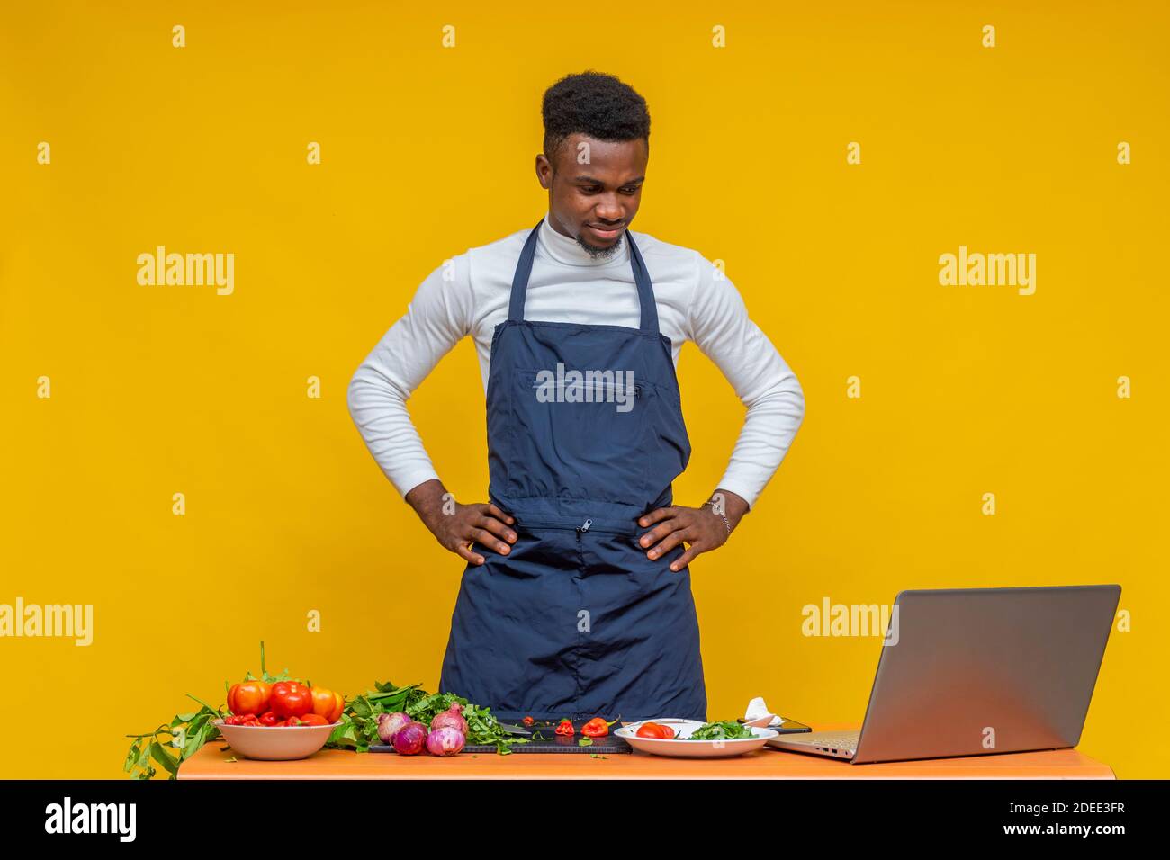 african chef using his laptop while cooking looking perplexed Stock ...