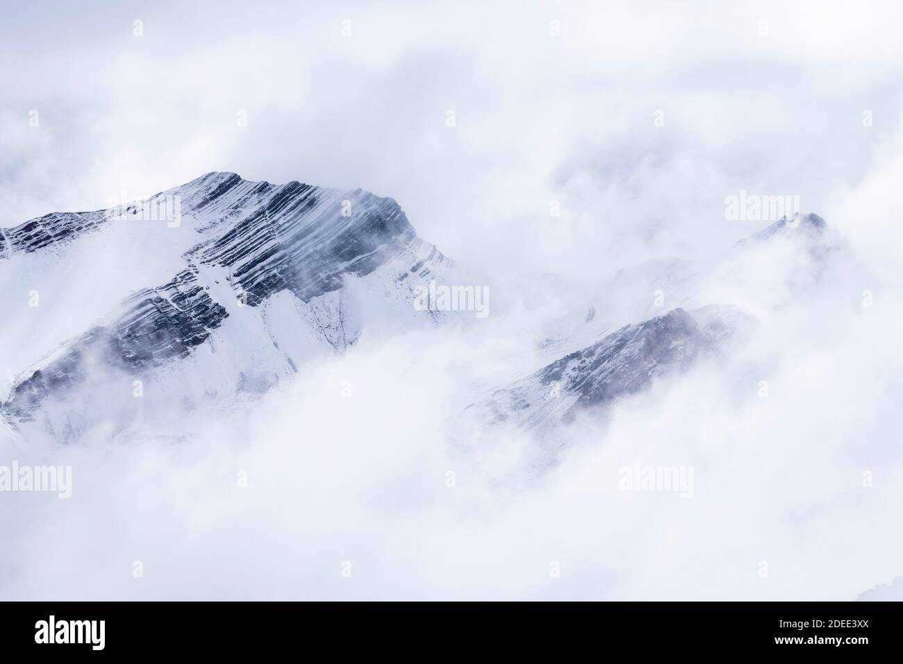 Snow-capped mountain peaks in the Andes revealing from fog, Rainbow ...