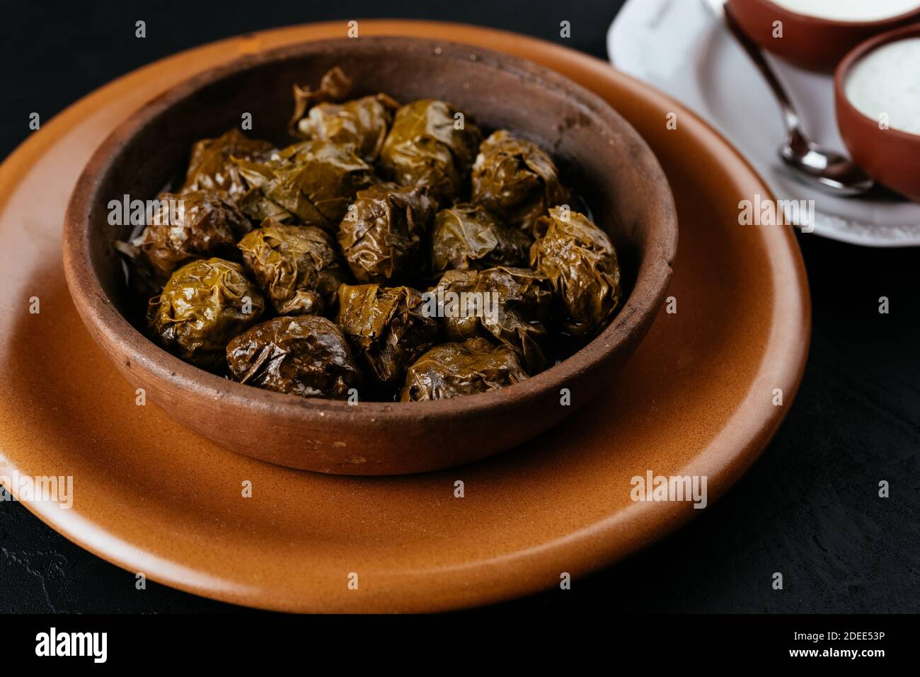 Georgian national dish dolma on a black background Stock Photo - Alamy