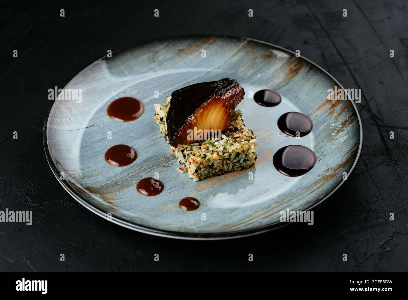 grilled fish with rice and vegetables on a black background Stock Photo ...