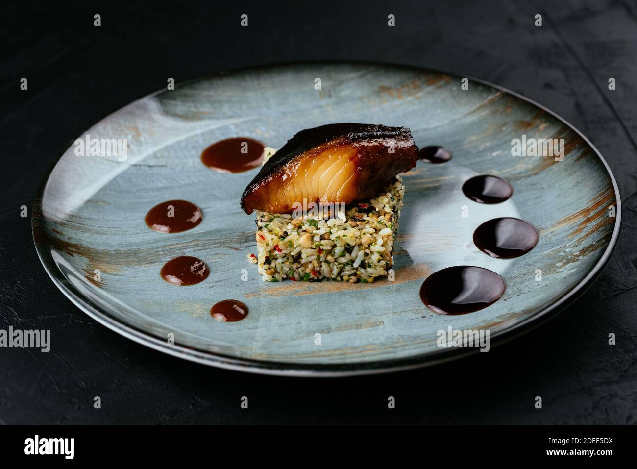 grilled fish with rice and vegetables on a black background Stock Photo ...
