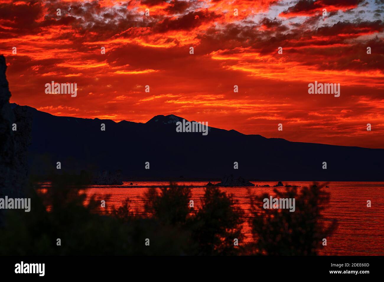 A mesmerizing shot of the silhouette of the eastern Sierra mountain range at deep red sunset ...
