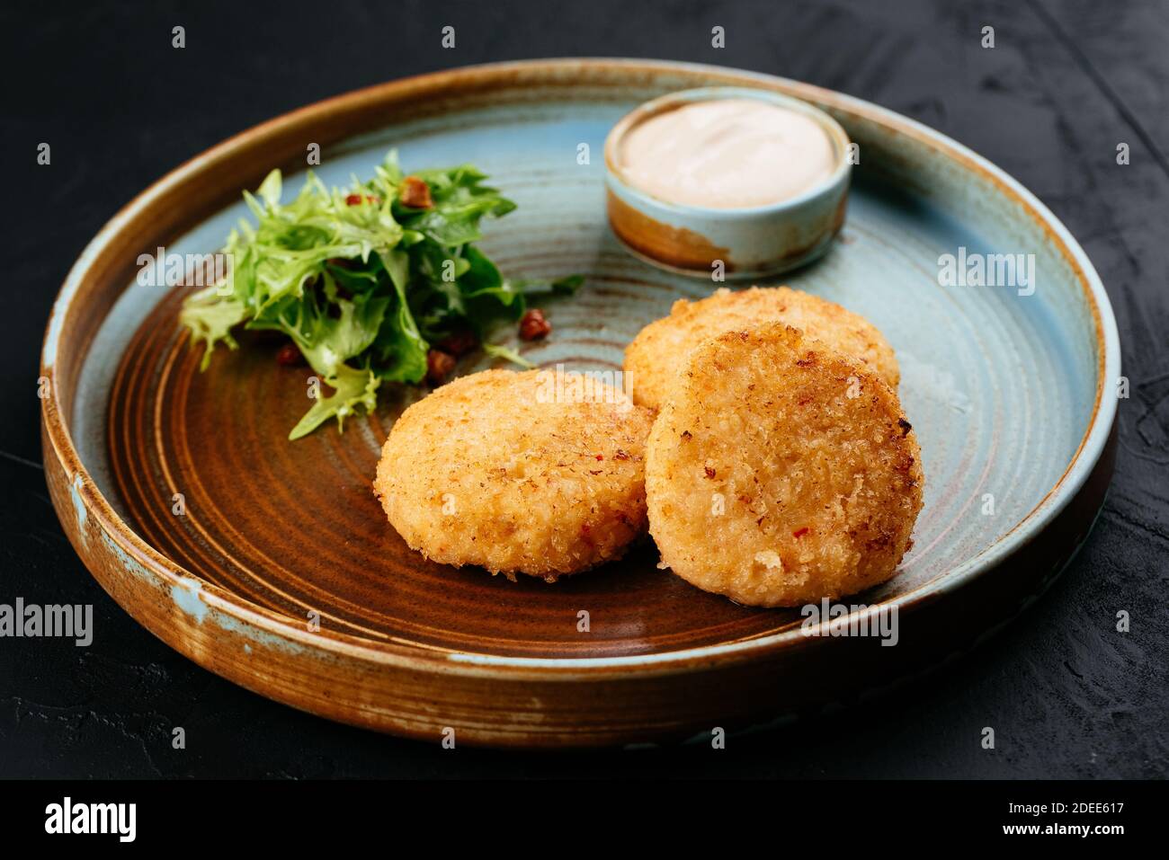 grilled salmon cutlets with sauce on a black background Stock Photo - Alamy