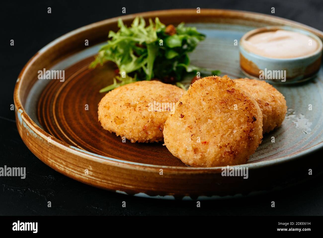grilled salmon cutlets with sauce on a black background Stock Photo - Alamy