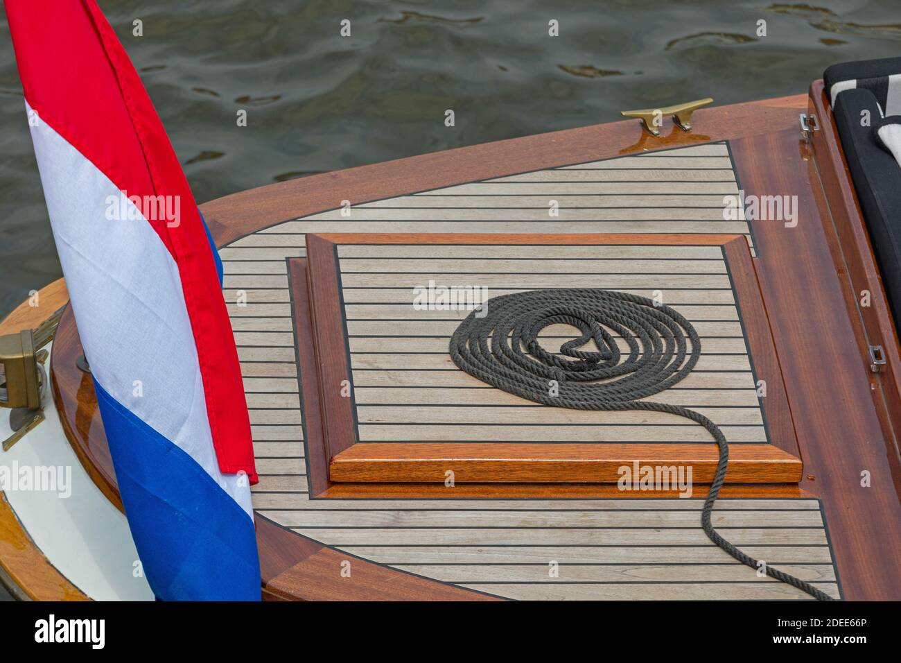 Rope Coil at Wooden Deck Boat With Flag Stock Photo - Alamy