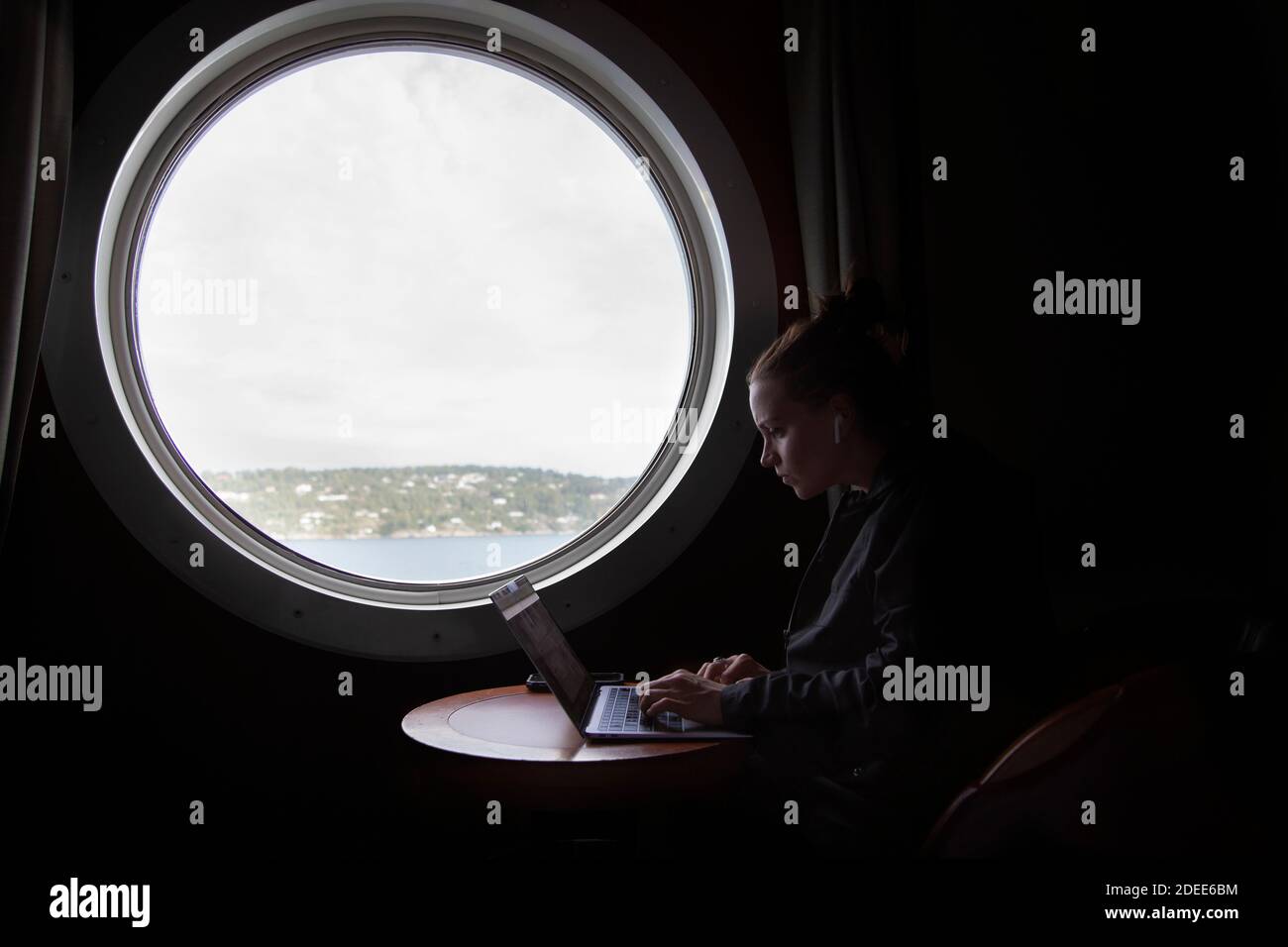 A young executive working intensely on her laptop on a ship Stock Photo ...
