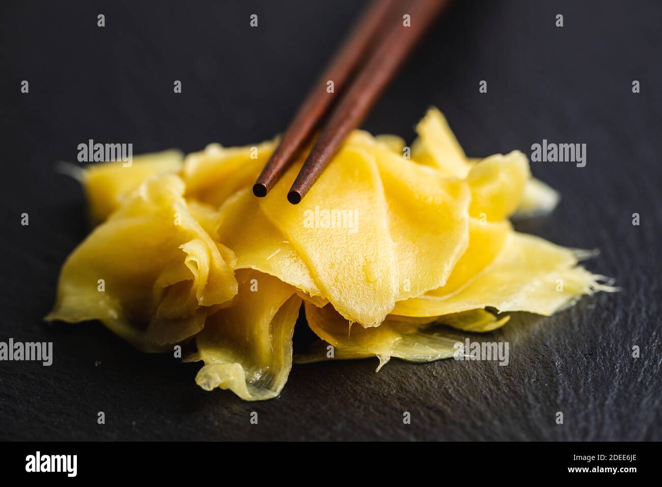 Pickled sushi ginger slices on black stone cutting board Stock Photo ...