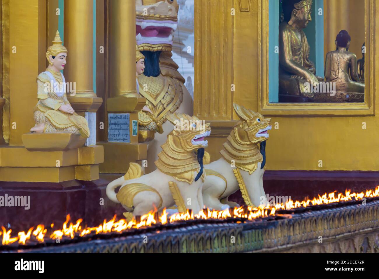 Golden chinthe (half lion, half dragon) statues sculptures with candles ...