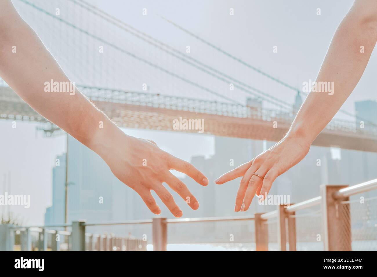 Two hands almsot touching against skyline Stock Photo - Alamy