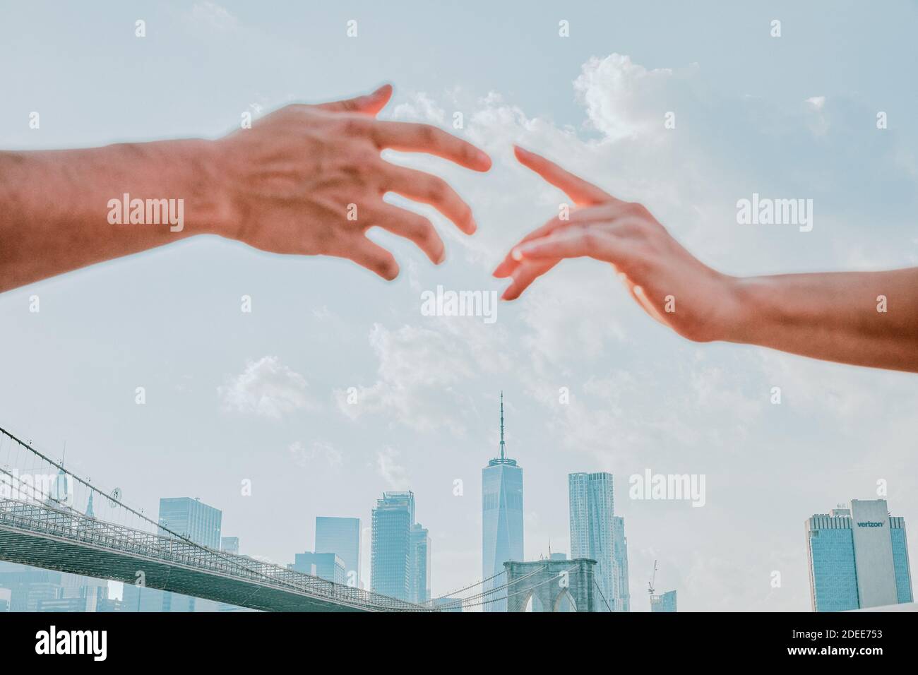 Two hands almsot touching against skyline Stock Photo - Alamy