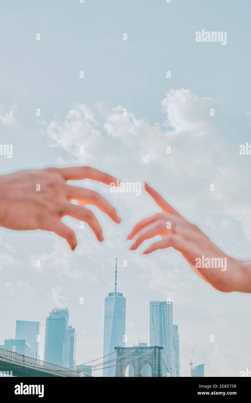 Two hands almsot touching against skyline Stock Photo - Alamy