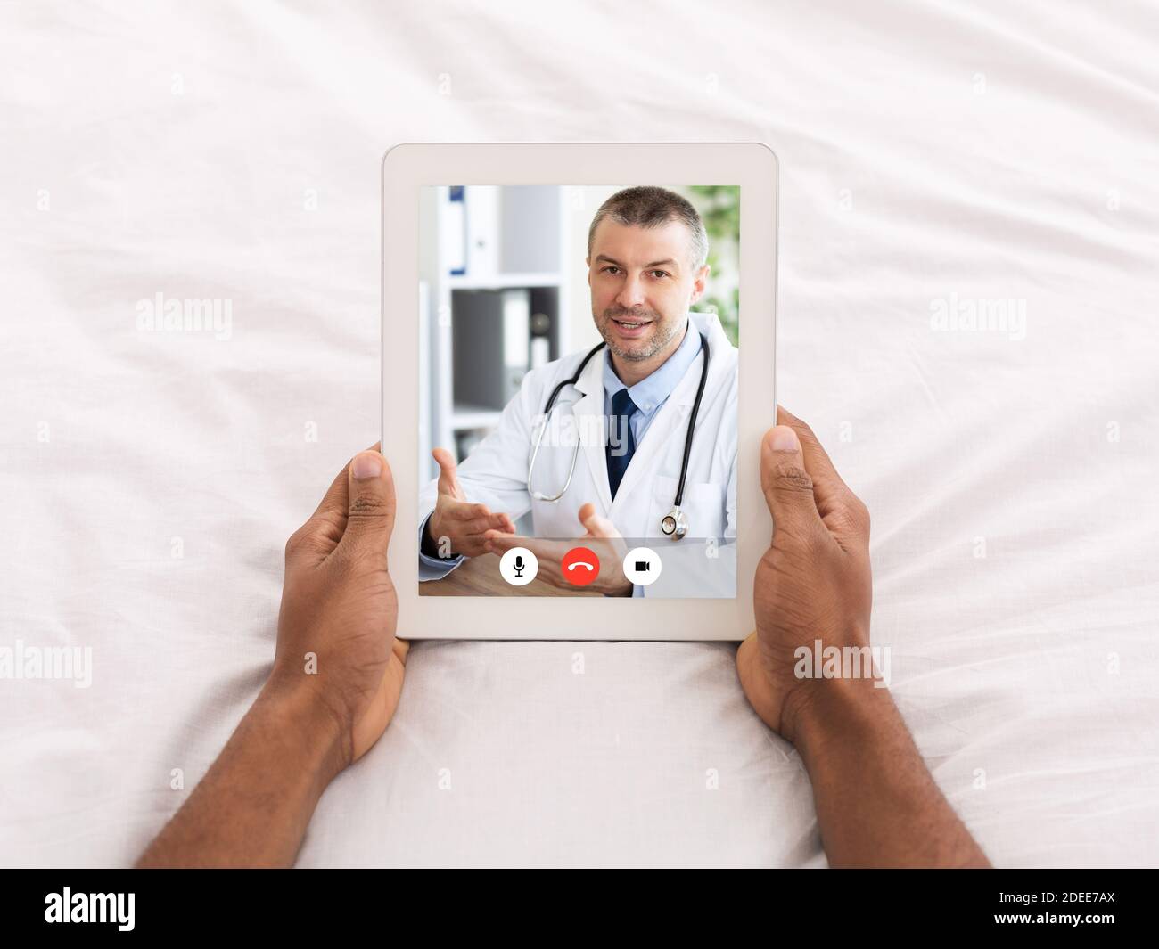 Sick Man Calling Doctor Online Via Tablet Lying In Bed Stock Photo - Alamy