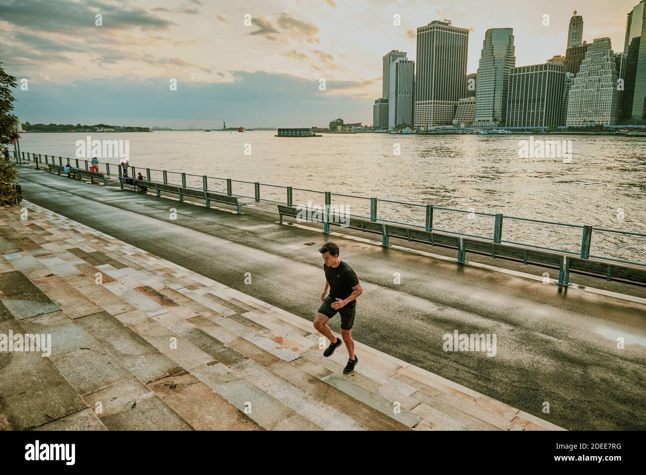 Male athlete running on steps during sunset Stock Photo - Alamy