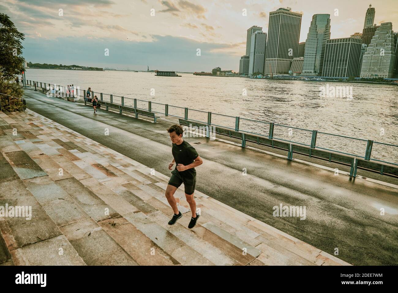 Male athlete running on steps during sunset Stock Photo - Alamy