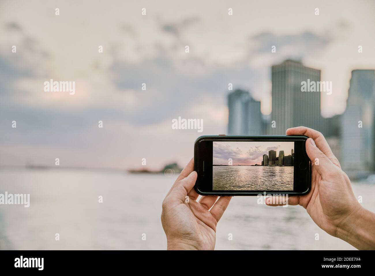Phone taking picture of new york city skyline at sunset Stock Photo - Alamy