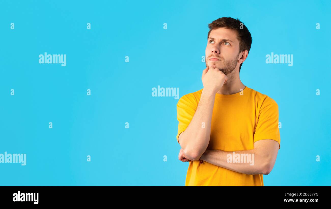 Pensive guy thinking about question, touching chin Stock Photo - Alamy