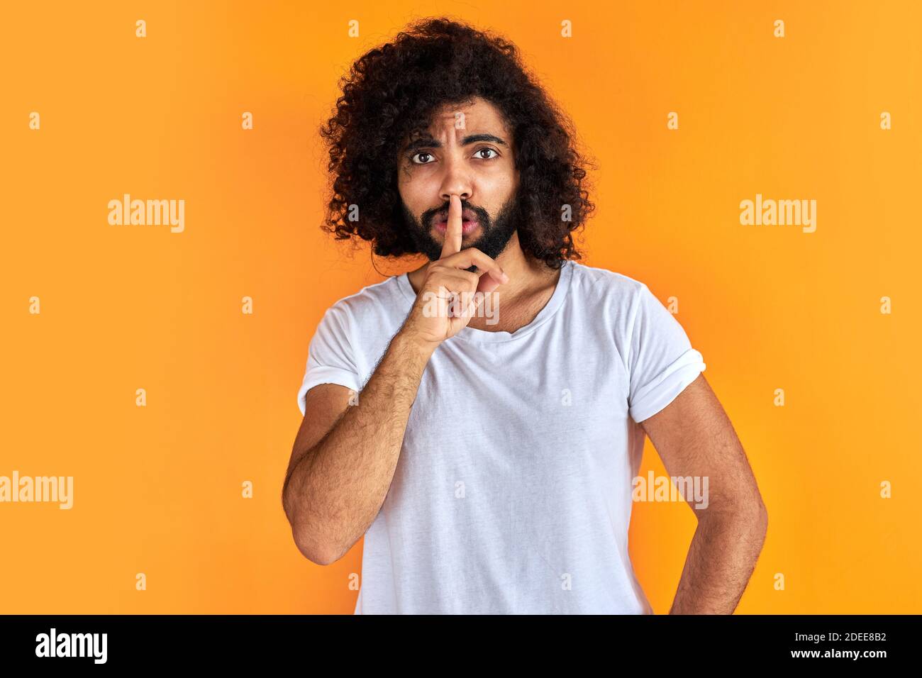 indian arabic male asking to be quiet with finger on lips, silence and ...