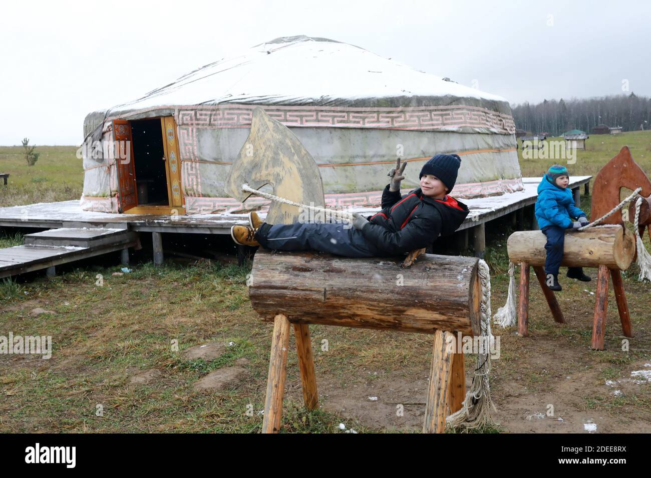 Children sitting on wooden horses in front of Yakut yurt Stock Photo ...