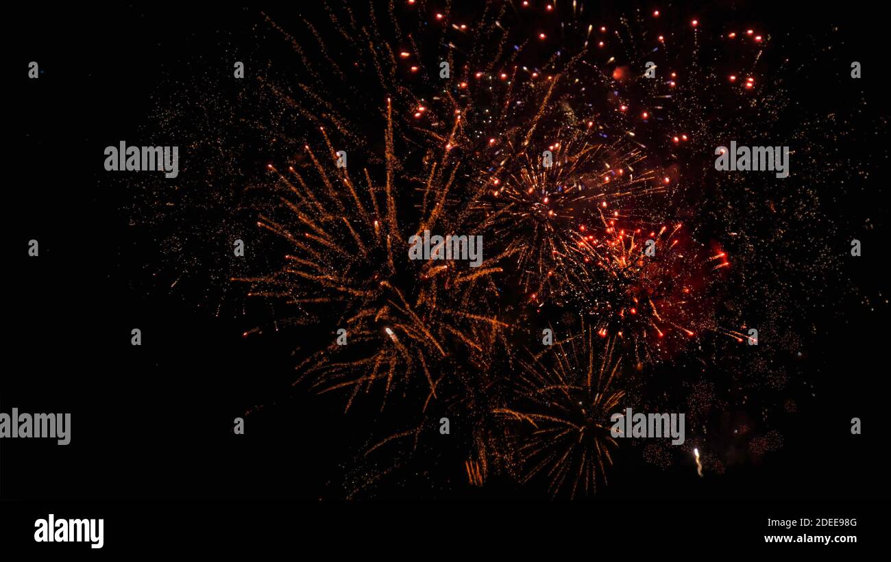 Red vibrant fireworks display on black night background Stock Photo - Alamy