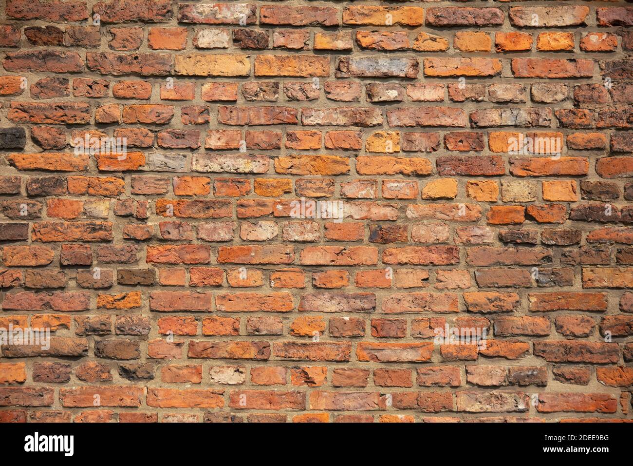 A rustic and old looking brick wall with textured brickwork and red ...