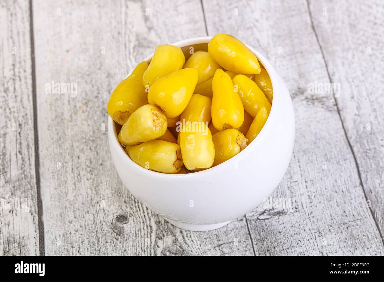 Pickled Yellow spicy mini pepper in the bowl Stock Photo - Alamy