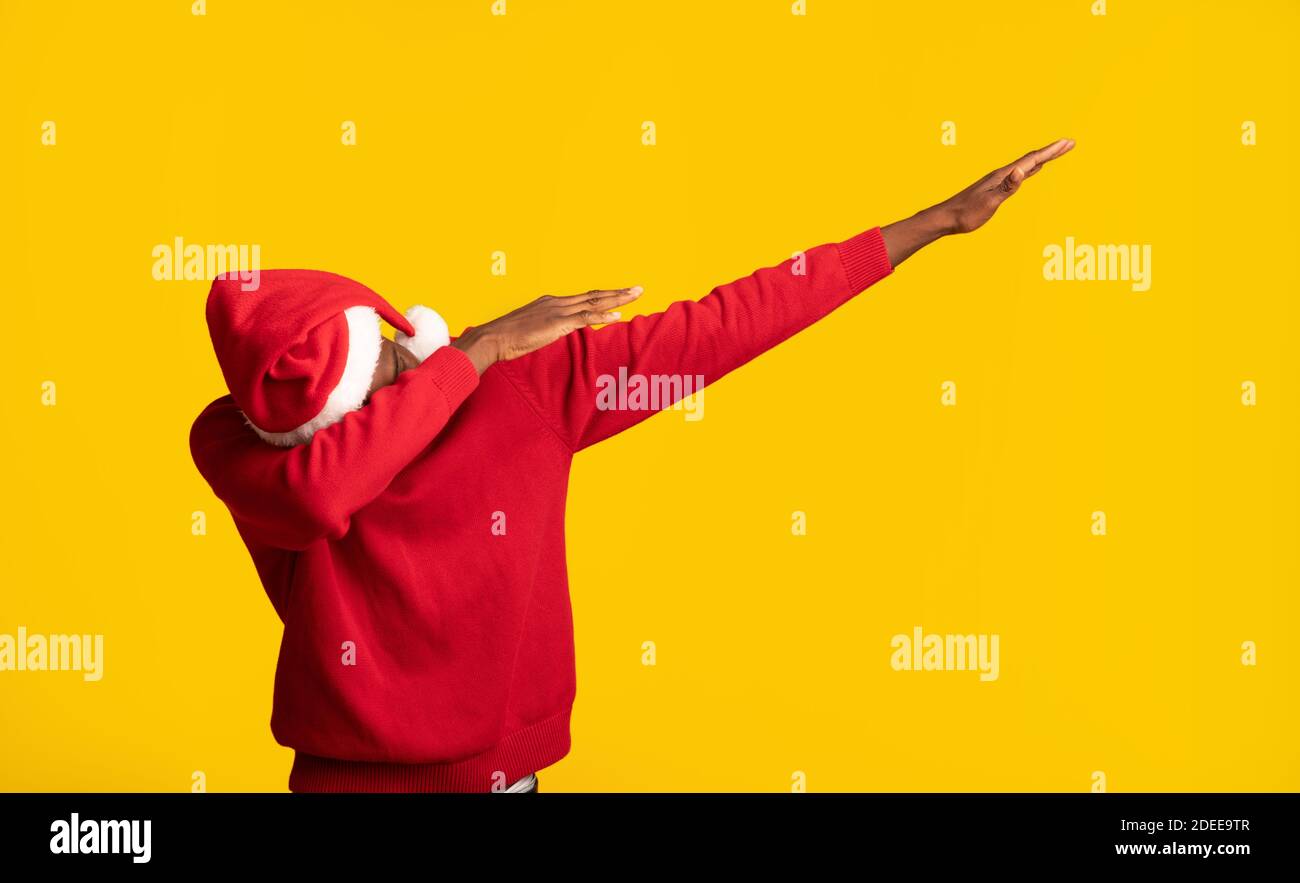 African american guy in santa hat throwing dab move over yellow ...