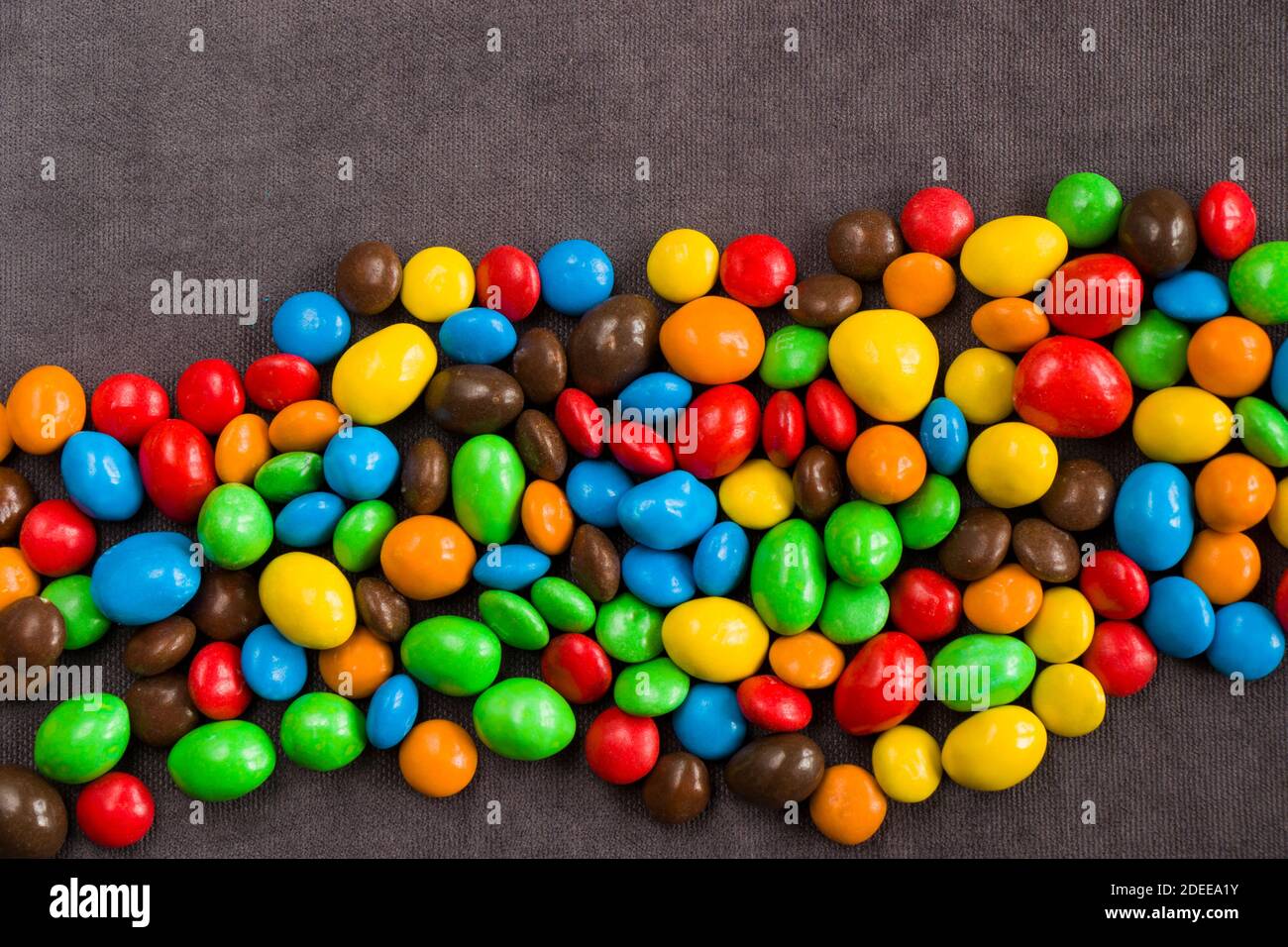 Chocolate candy on the gray background, colorful candy texture, close ...