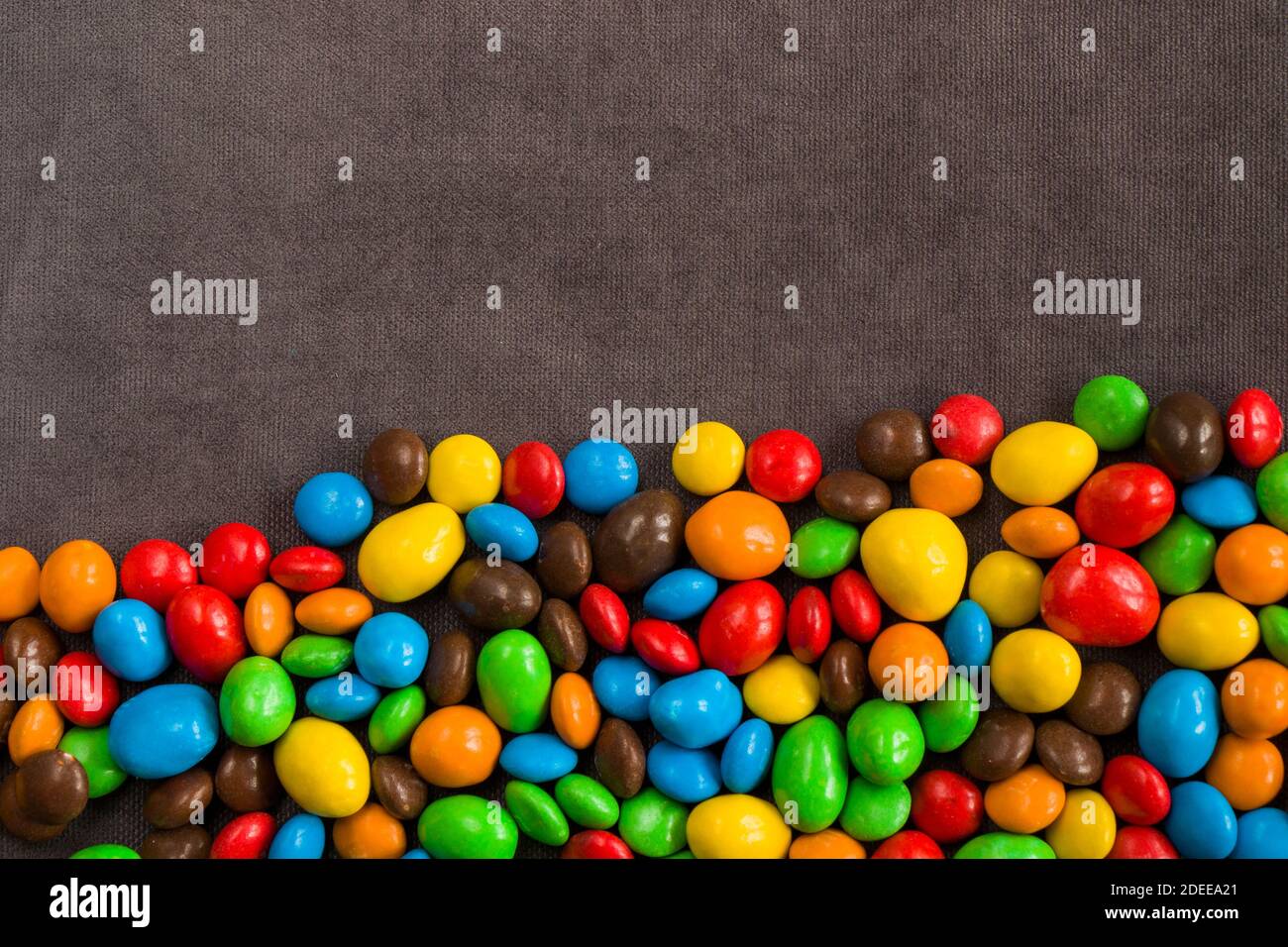 Chocolate candy on the gray background, colorful candy texture, close ...