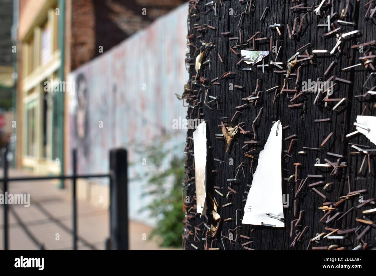 a Closeup of remaining staples from multiple fliers on a bulletin board ...