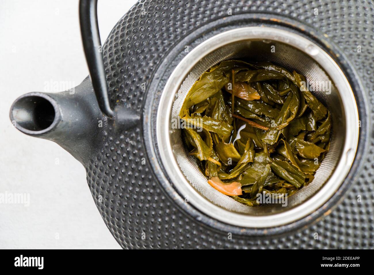 Herbal tea, iron teapot and cup of tea on the white background, chinese ...