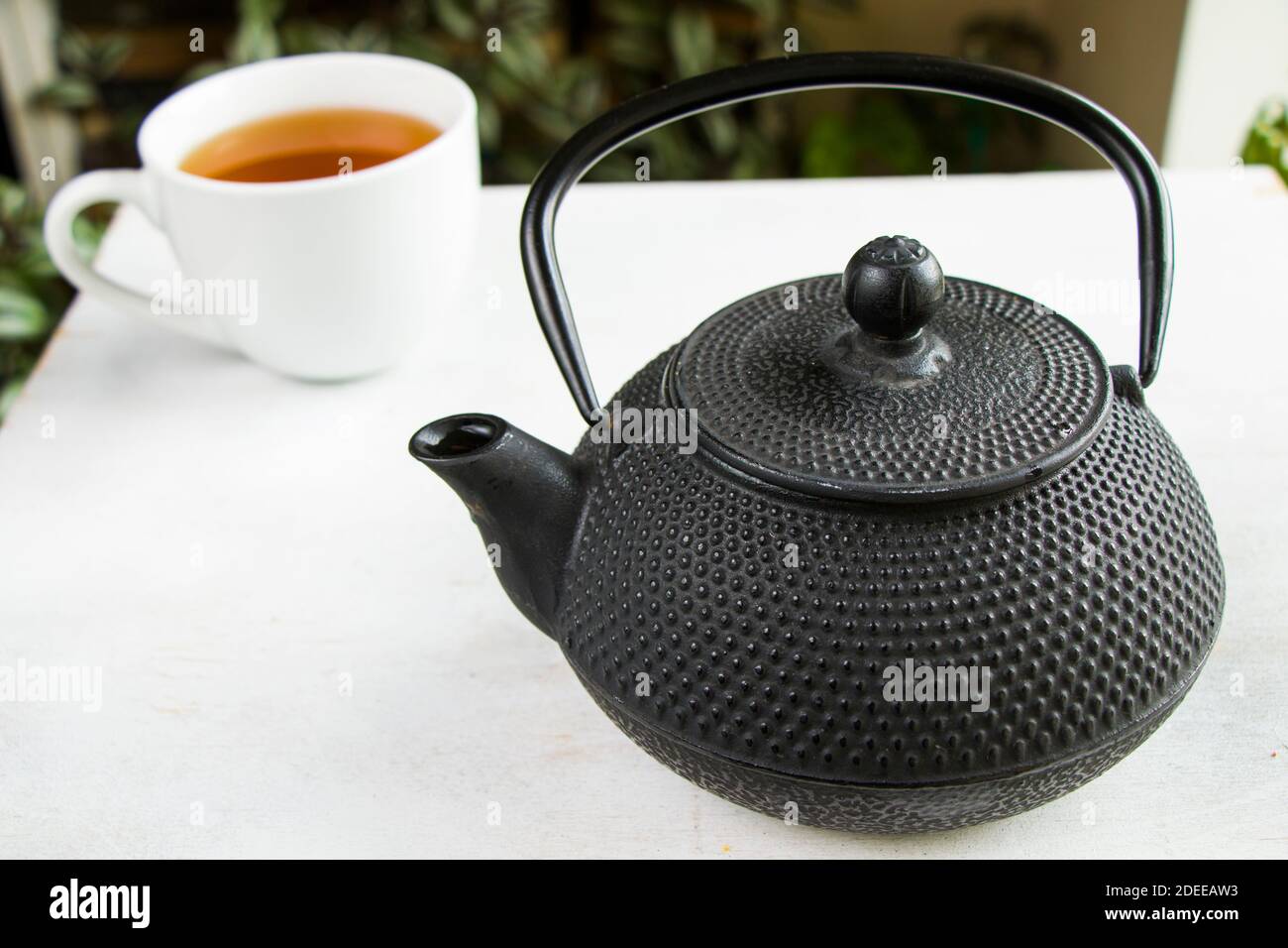 Herbal tea, iron teapot and cup of tea on the white background, chinese ...