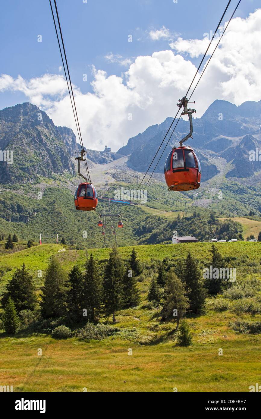 View of a cable car on Alps in summer time Stock Photo - Alamy