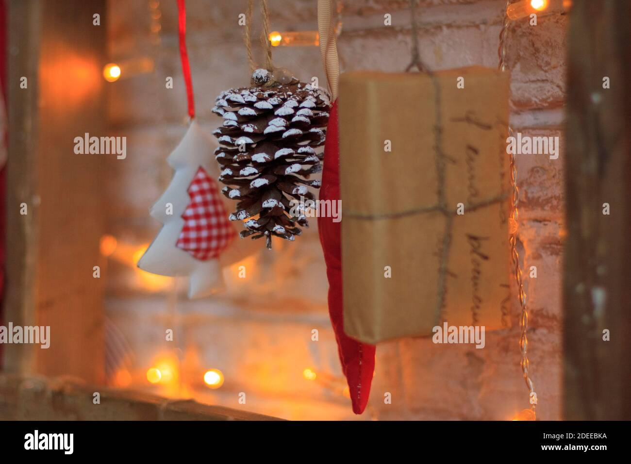 A garland of Christmas decorations, a small gift, pine cones, Christmas ...