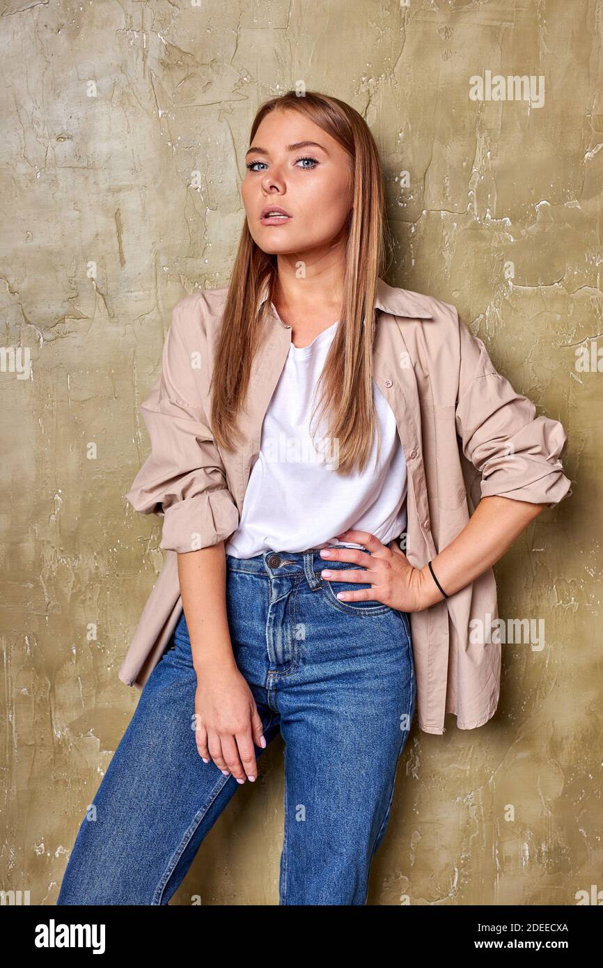 charming good-looking female in casual outfit posing in studio with ...