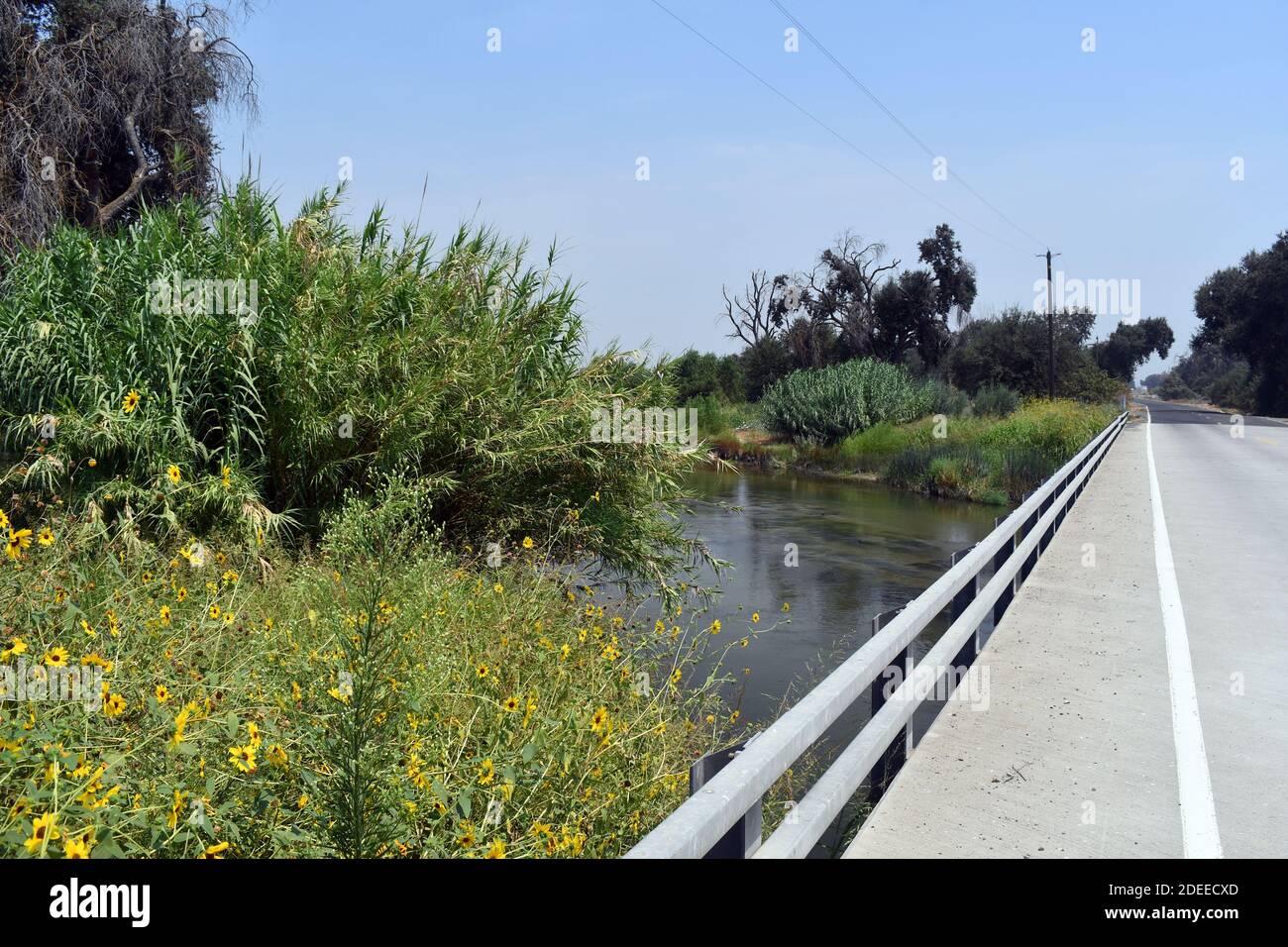 A paved bridge road winding through a flowing stream of water Stock ...