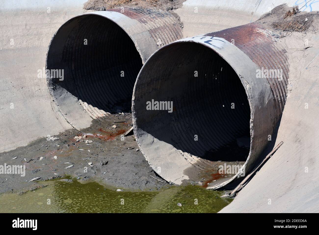Old rusty fat wastewater pipes in an old factory area Stock Photo - Alamy