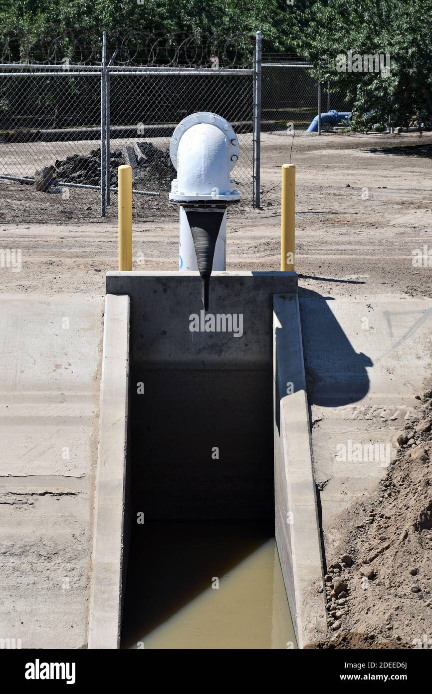 A vertical shot of a drainage wastewater pipe in an industrial area ...