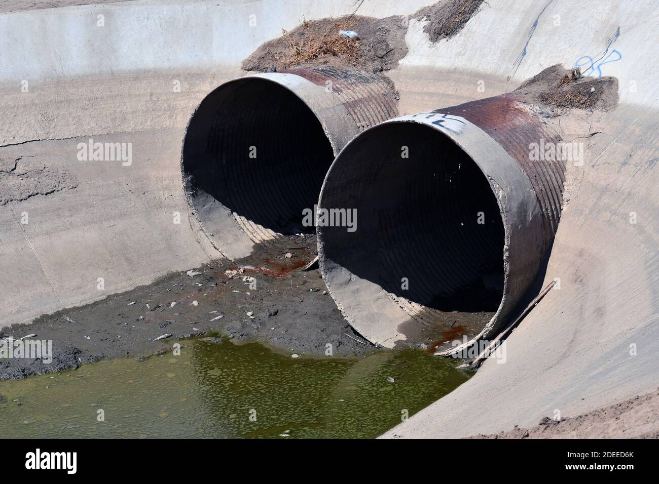 Old rusty fat wastewater pipes in an old factory area Stock Photo - Alamy