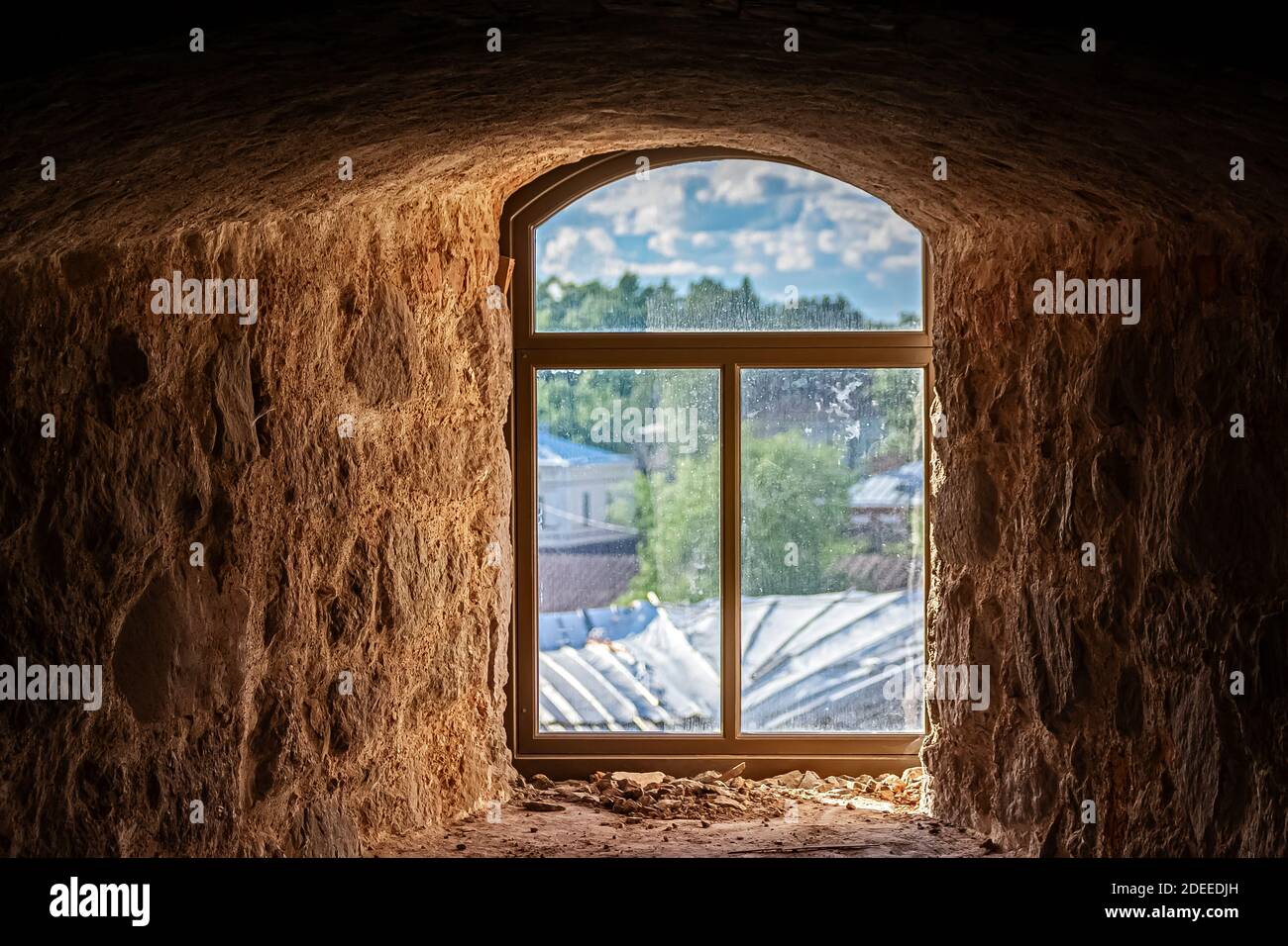 Arched window with a rectangular frame in the recess of the old red ...