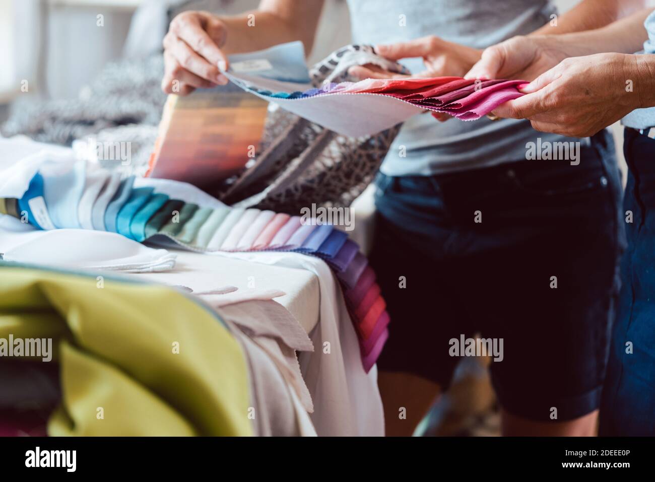 Hands on fabric pattern palette on studio table Stock Photo - Alamy
