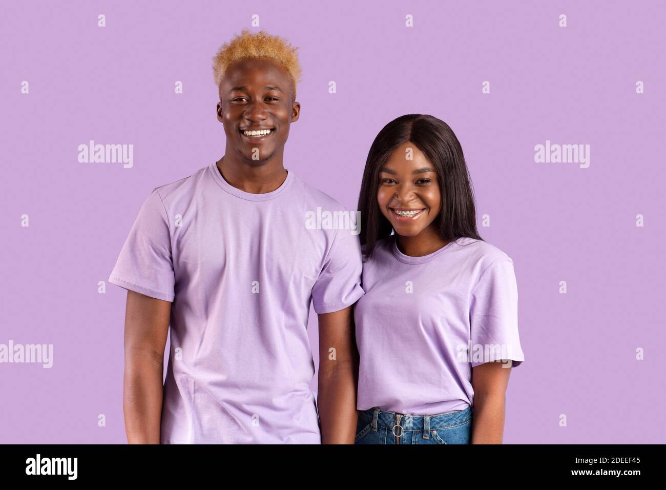 Positive African American couple smiling and looking at camera on ...